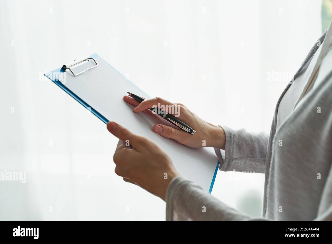 Woman holding clipboard, concept of office work or studying student ...