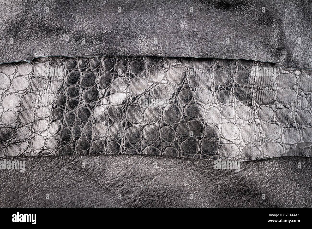 Black leather and fake artificial alligator skin textures background ...