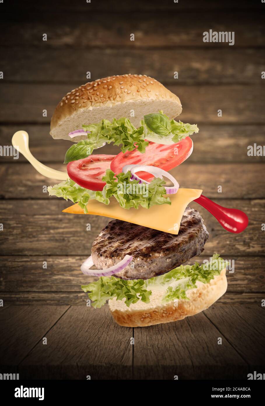Burger explosion with salad and sauce Stock Photo - Alamy