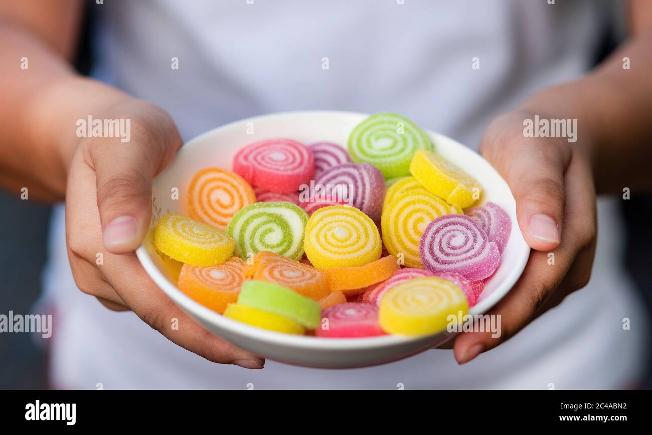 Close up hand holding a dish of Jelly Candy Variety of colors Stock ...