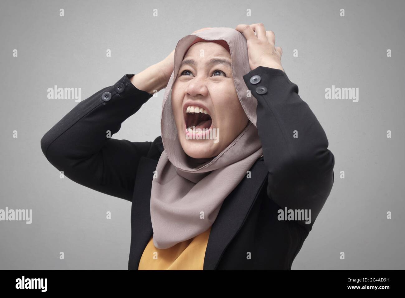 Portrait of Asian muslim lady wearing hijab shows angry screaming ...