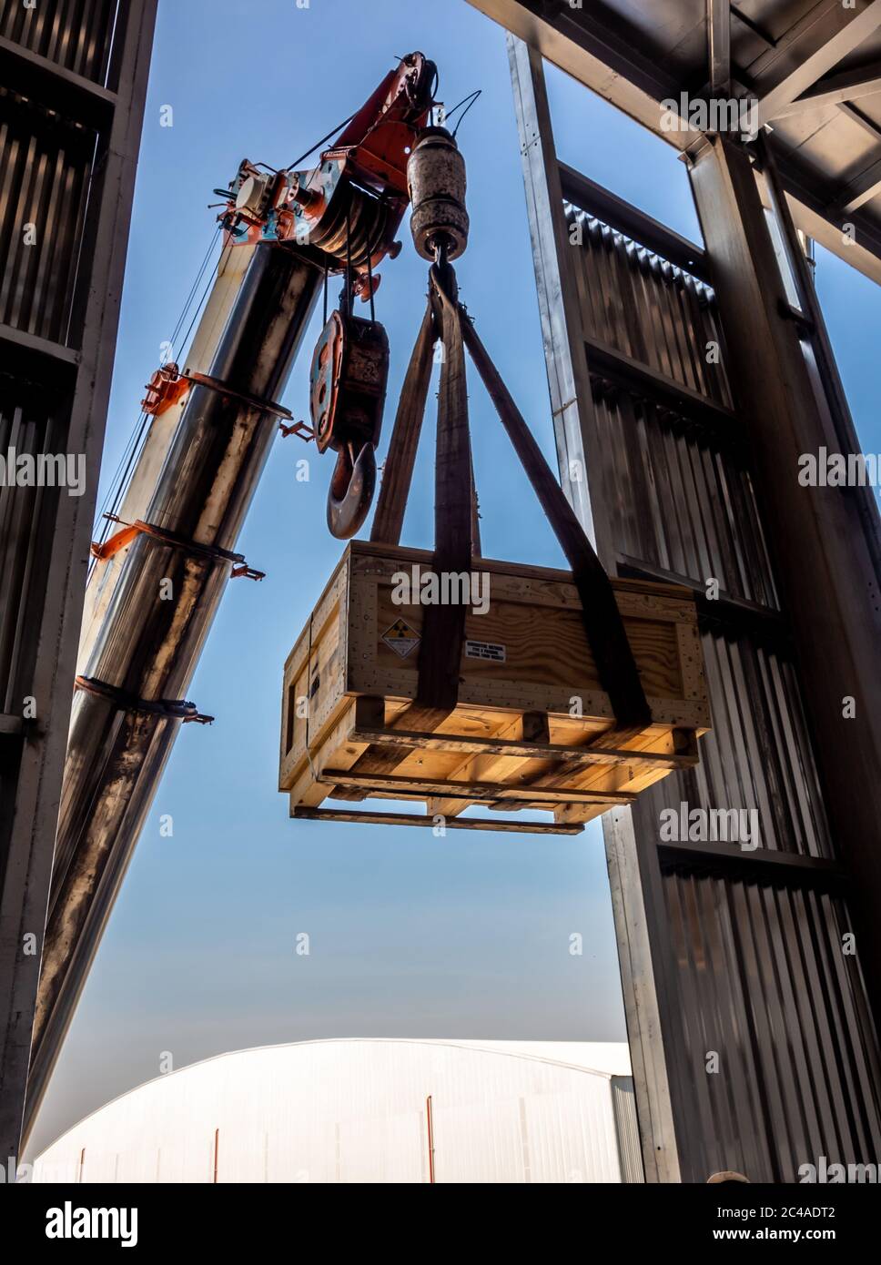 The crane carrying a wooden box of the radioactivity holder into the ...
