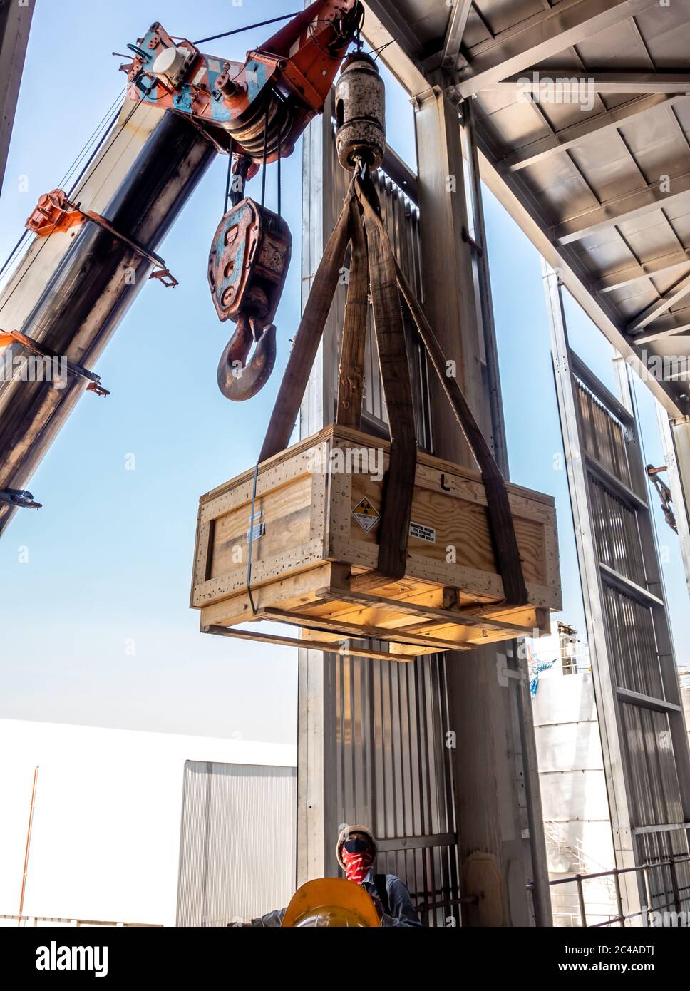The crane carrying a wooden box of the radioactivity holder into the ...