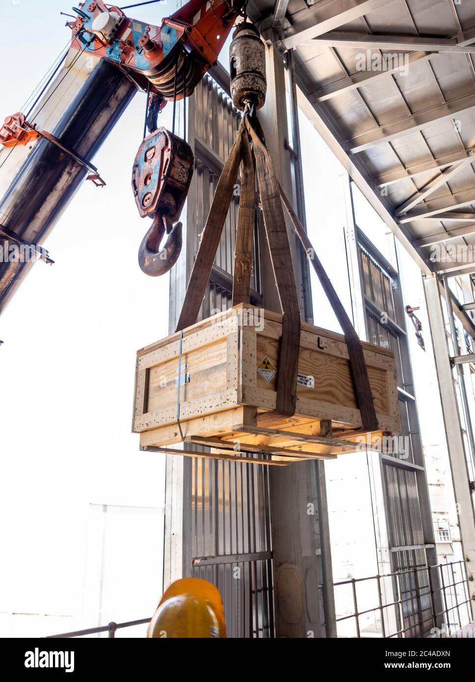 The crane carrying a wooden box of the radioactivity holder into the ...