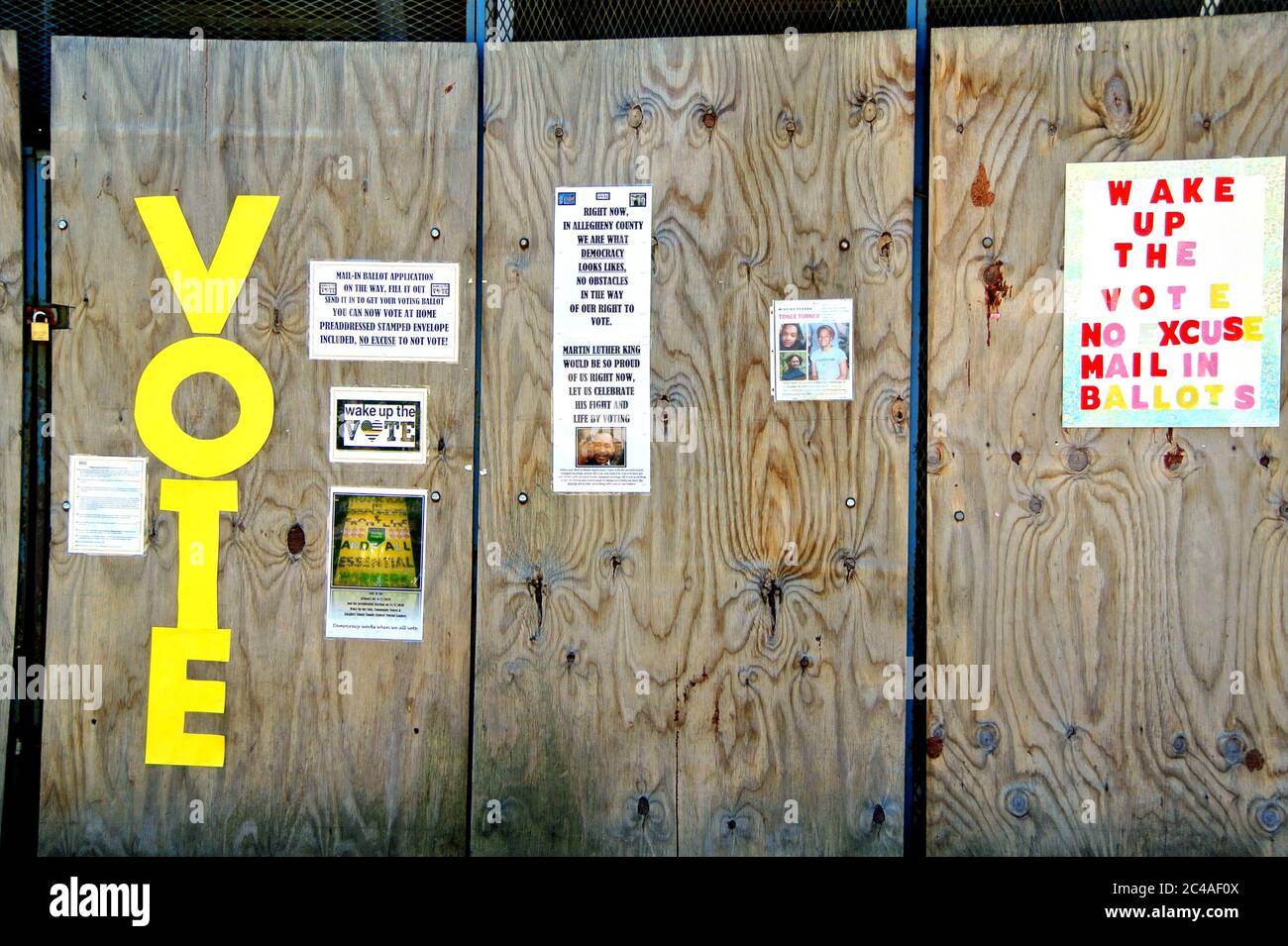 sign on plywood covered wall urging residents of low income ...