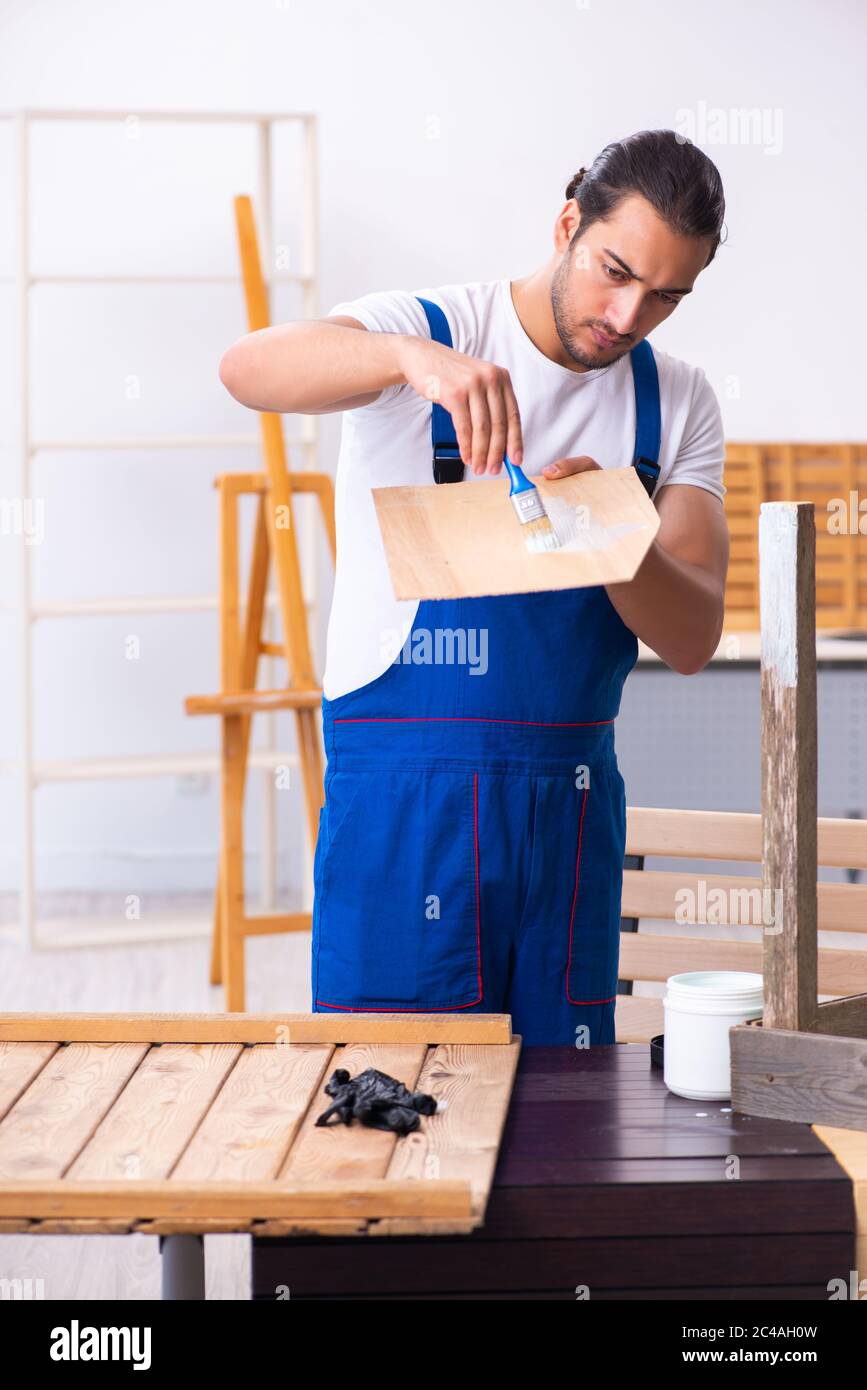 Young male contractor working in the workshop Stock Photo - Alamy