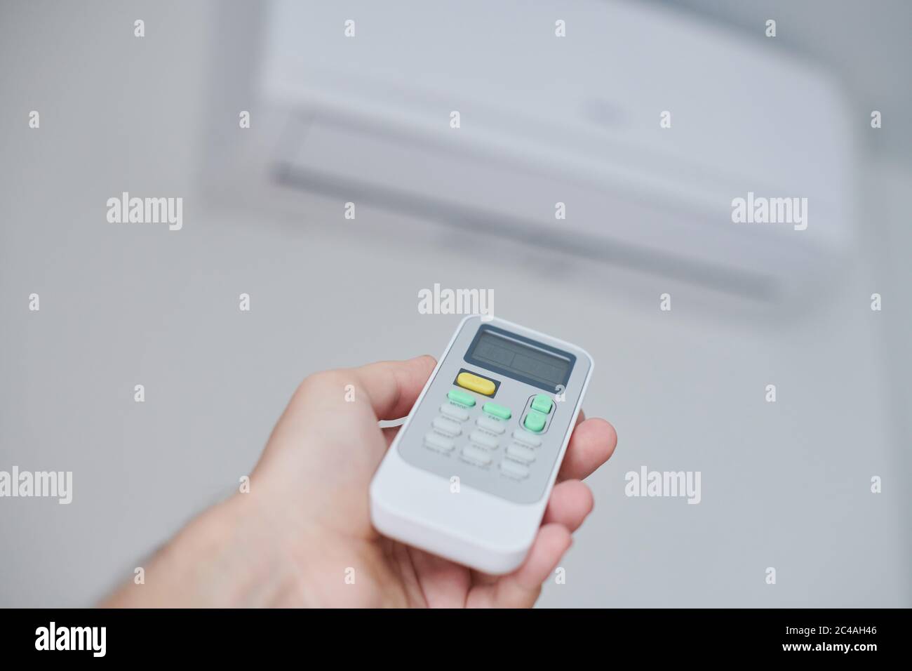 Air condition remote control. Hand with room conditioner remote control ...