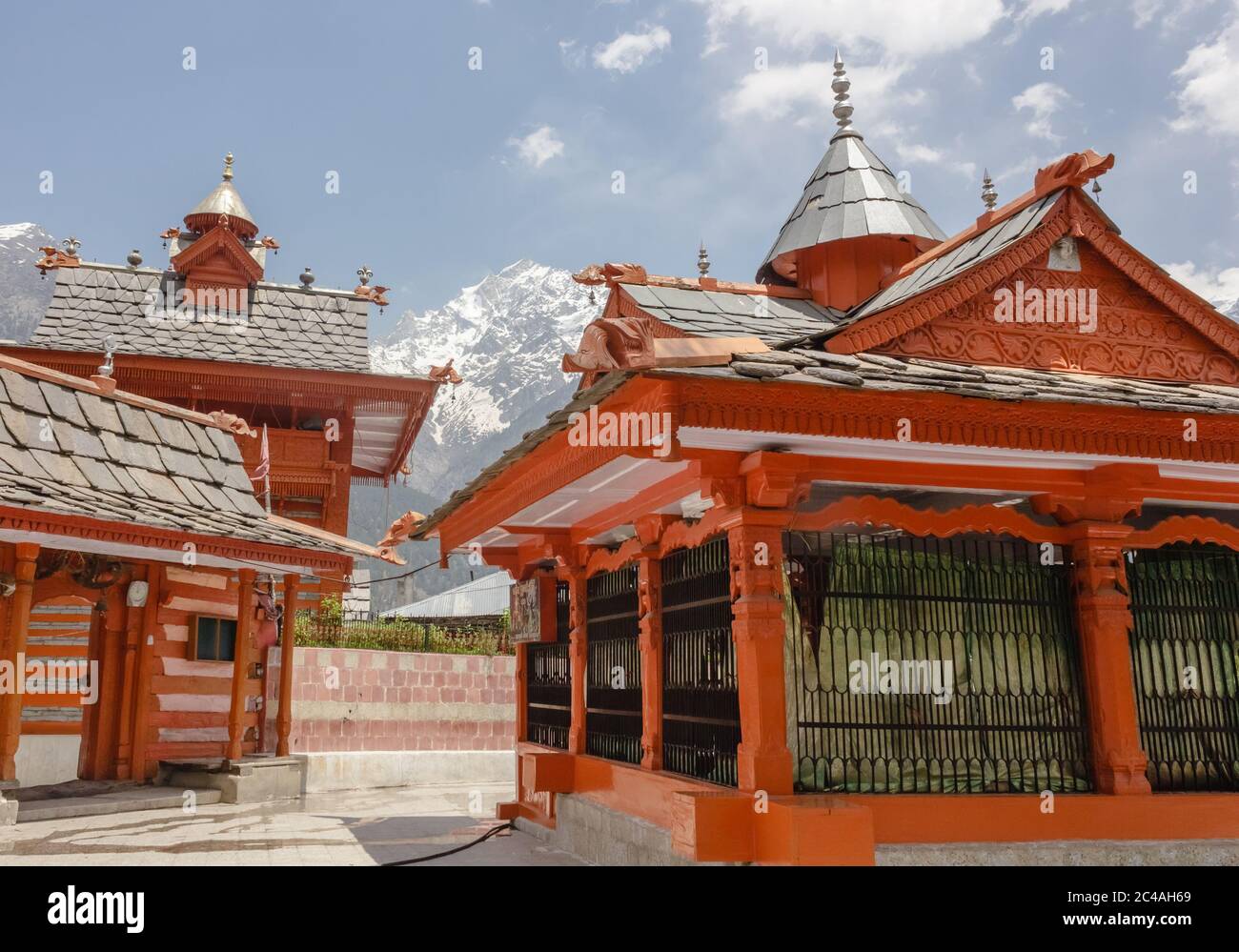 An ancient temple complex with the backdrop of the Kinner Kailash in ...