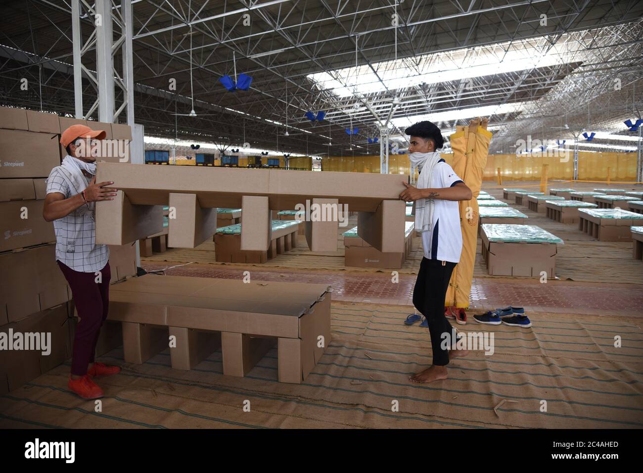 Workers assembling card board beds at a large 10,000 bed Covid 19 ...