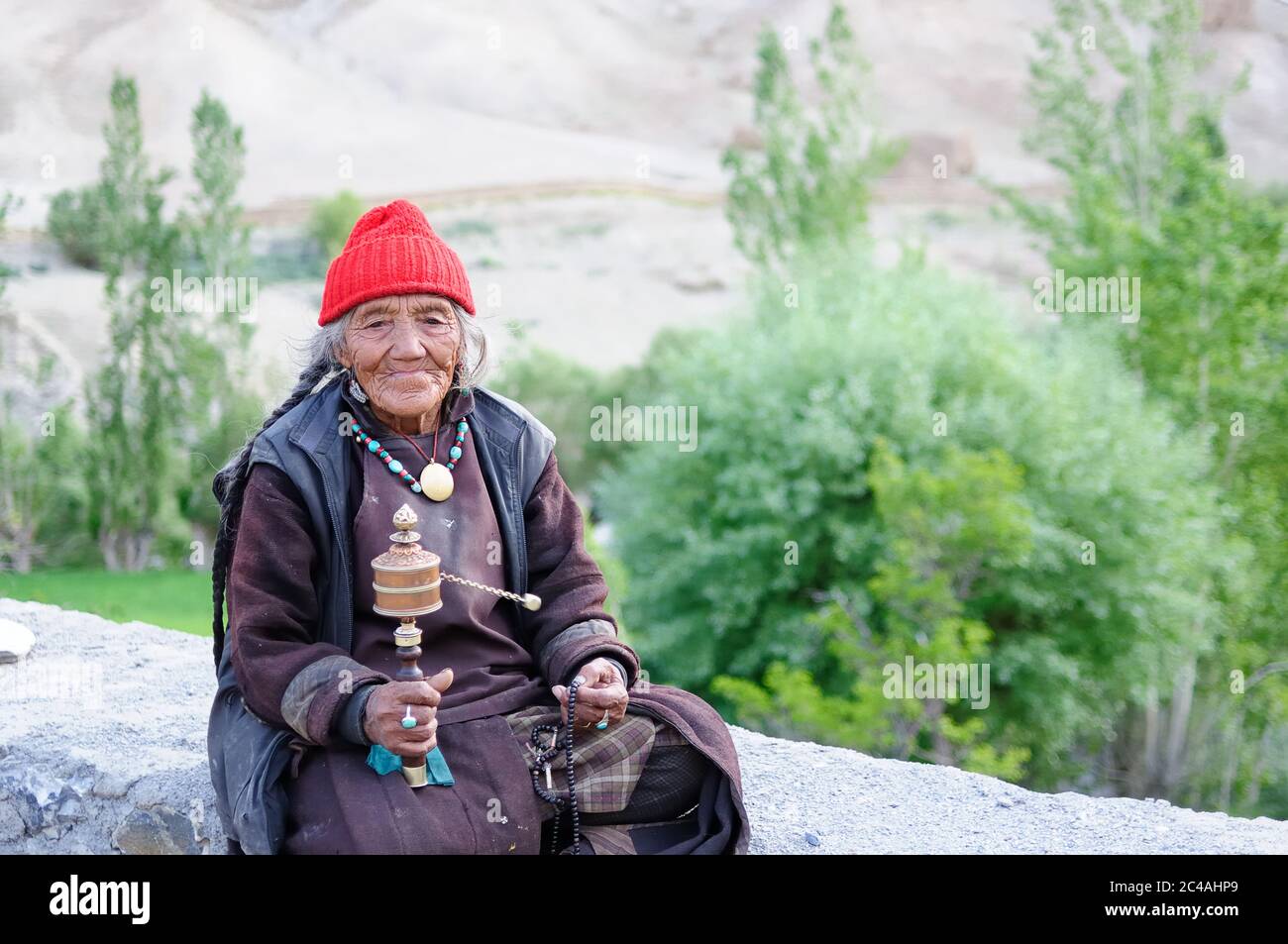 WANLA, INDIA June 26: Ladakhi woman with the traditional prayer wheel ...