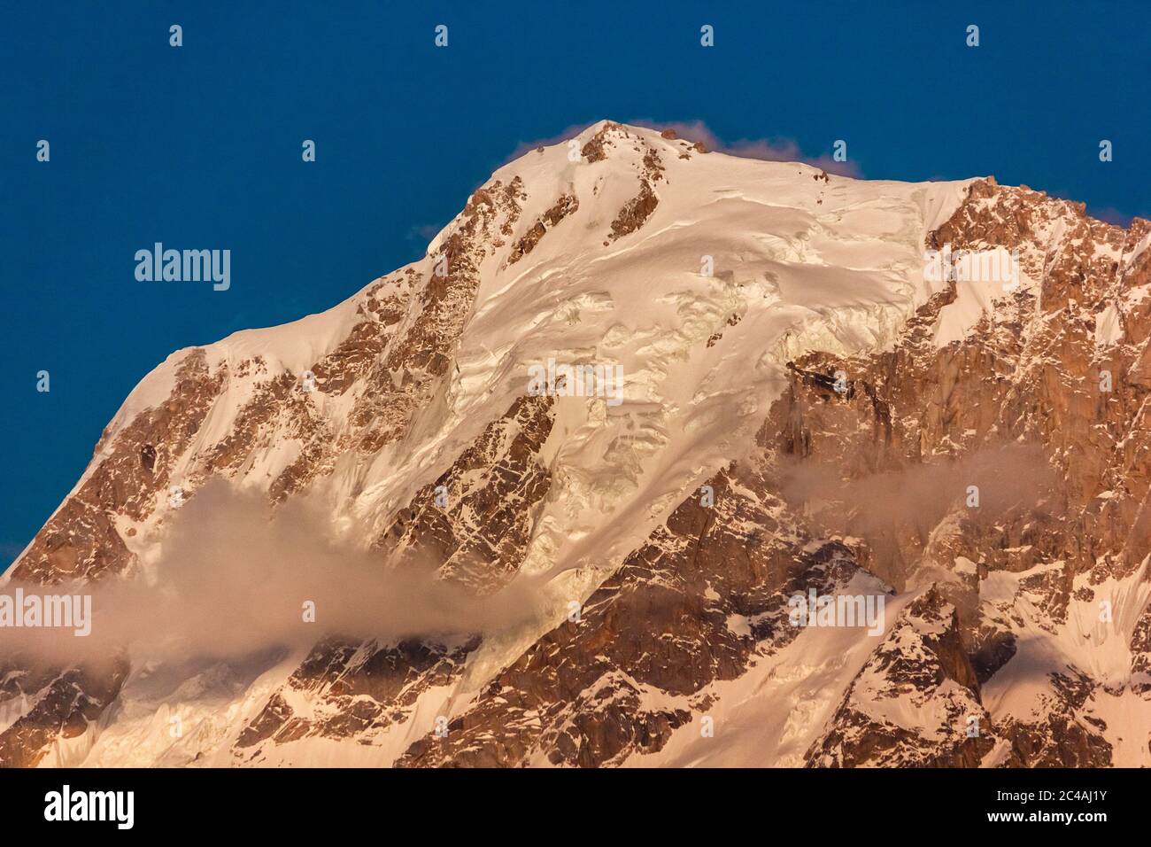 The beautiful view of a snow covered peak in a Himalayan mountain range ...