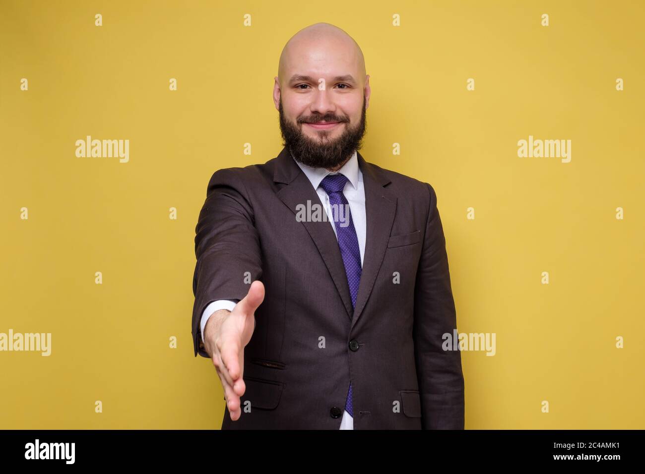 Business man with hand extended to handshake Stock Photo - Alamy
