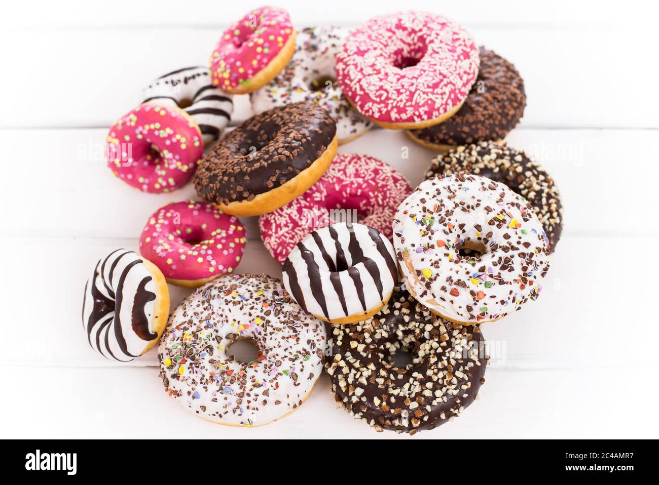 Colorful glazed donuts with sprinkles Stock Photo - Alamy