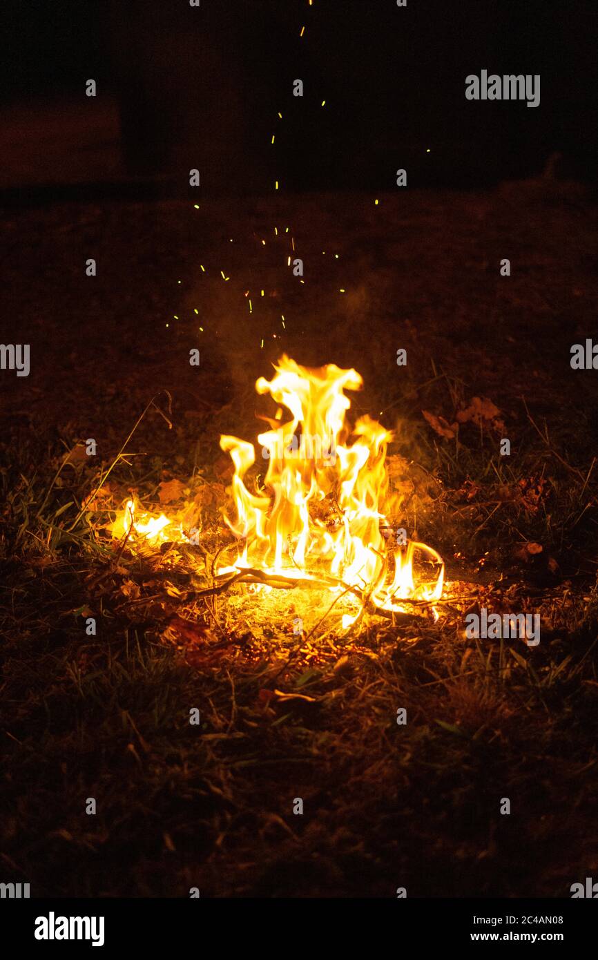 Small campfire in the middle of the field Stock Photo - Alamy