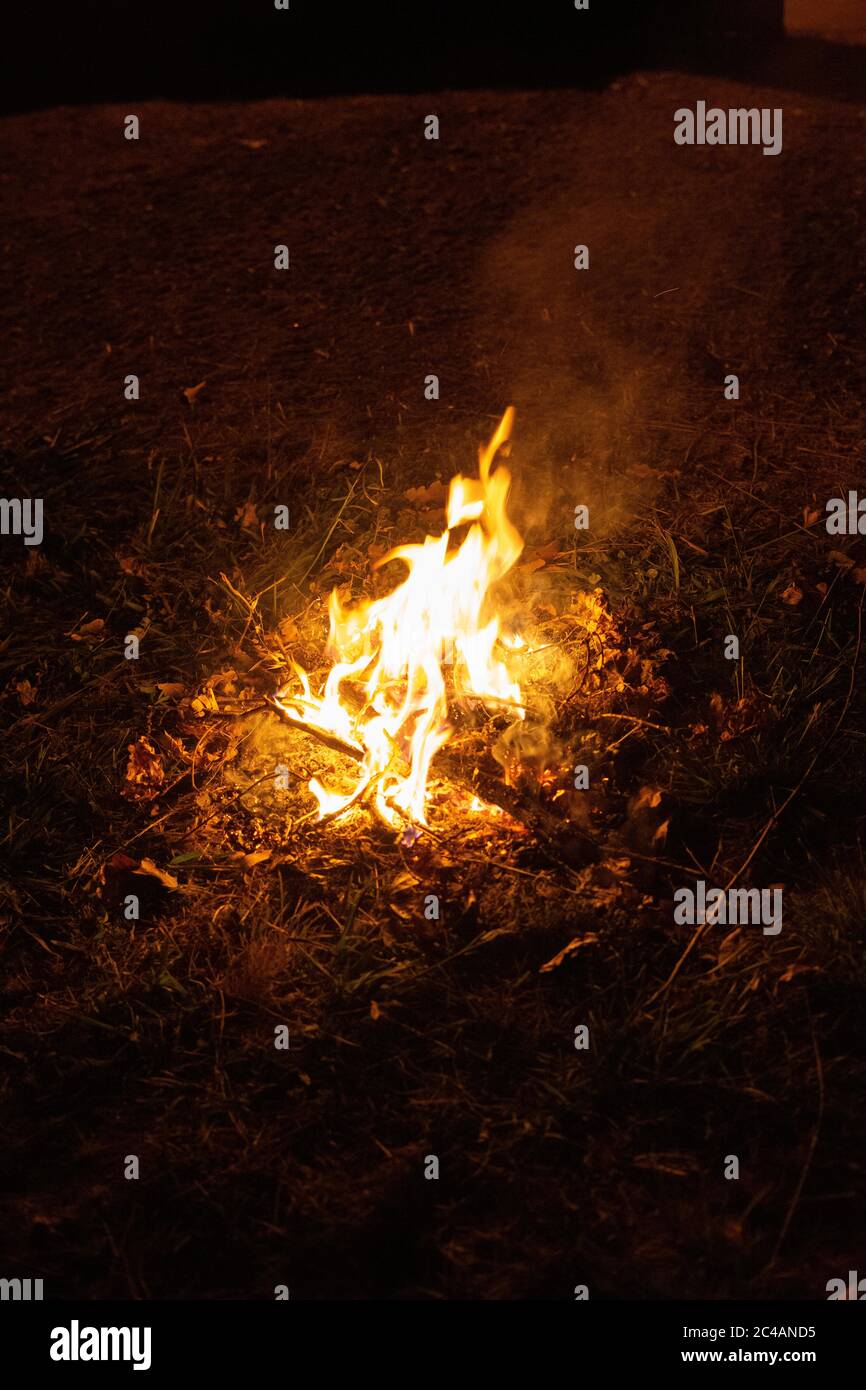 Small campfire in the middle of the field Stock Photo - Alamy
