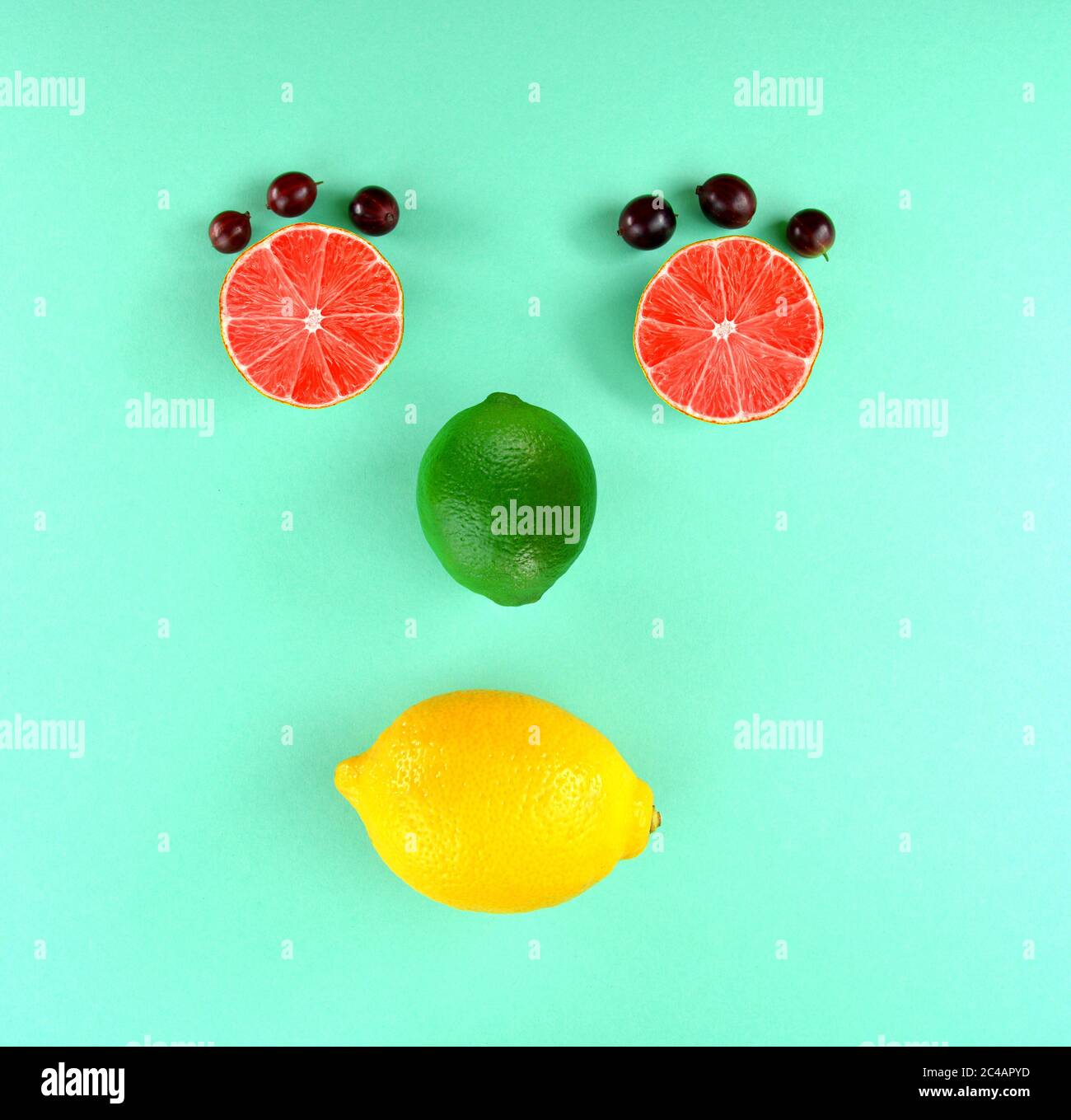 Grapefruit face. Fruit face. Lime isolate on turquoise background.Lime ...