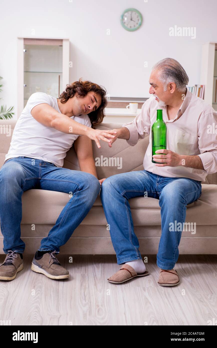 Drinking problems in the family between son and father Stock Photo - Alamy