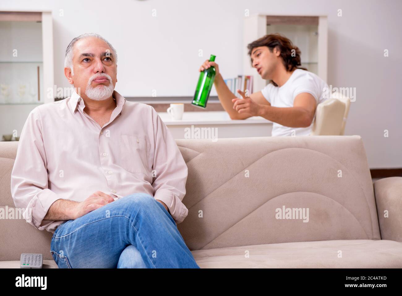 Drinking problems in the family between son and father Stock Photo - Alamy