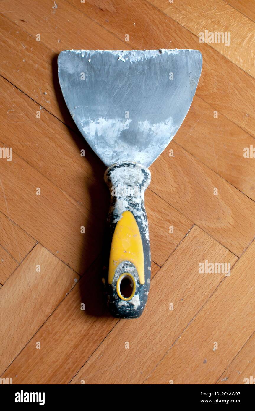 old dirty scraper on wooden floor close up Stock Photo - Alamy