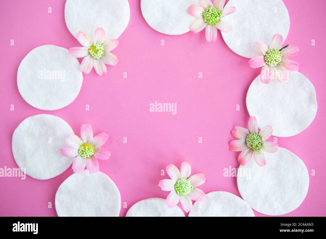 Cotton sponges frame on pink background, top view Stock Photo - Alamy