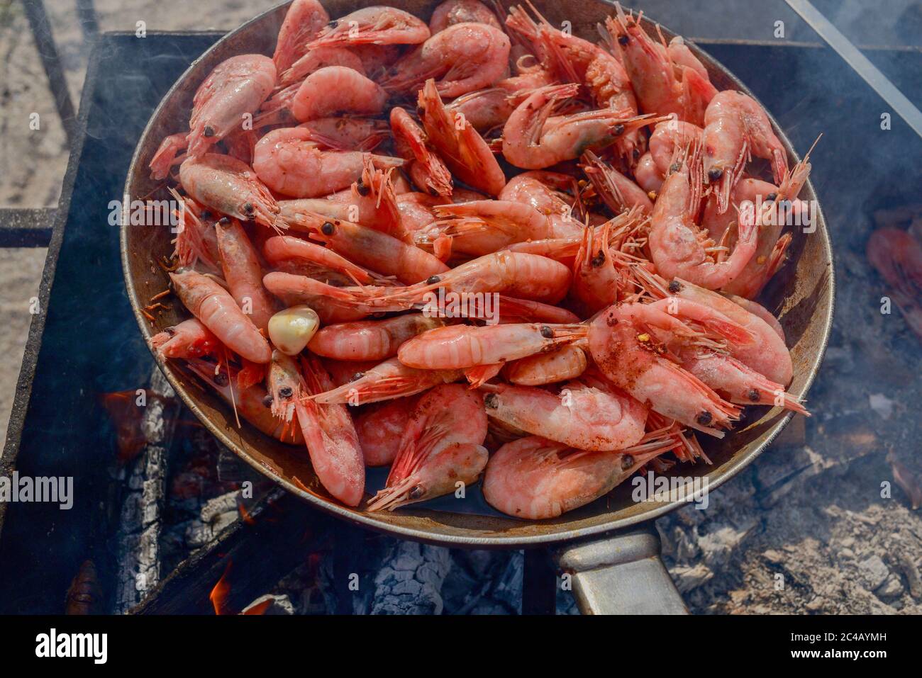 shrimp. Shrimps are cooked in a pan over a fire Stock Photo - Alamy