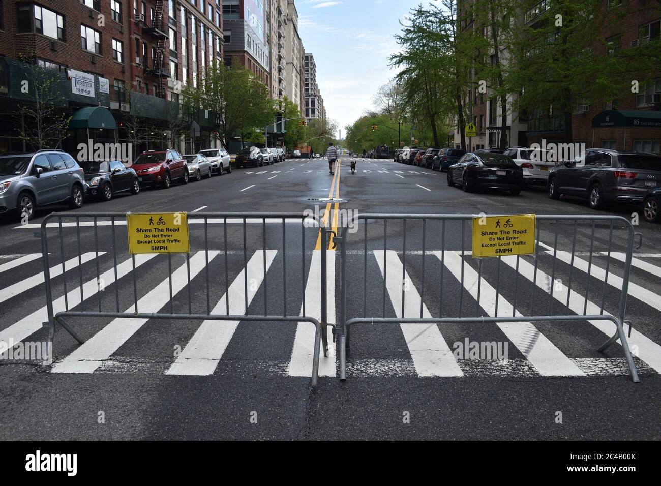 Metal barricades on a zebra crosswalk with signs reading "Share The ...