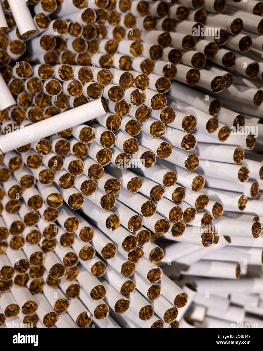 Many loose cigarettes background Stock Photo - Alamy