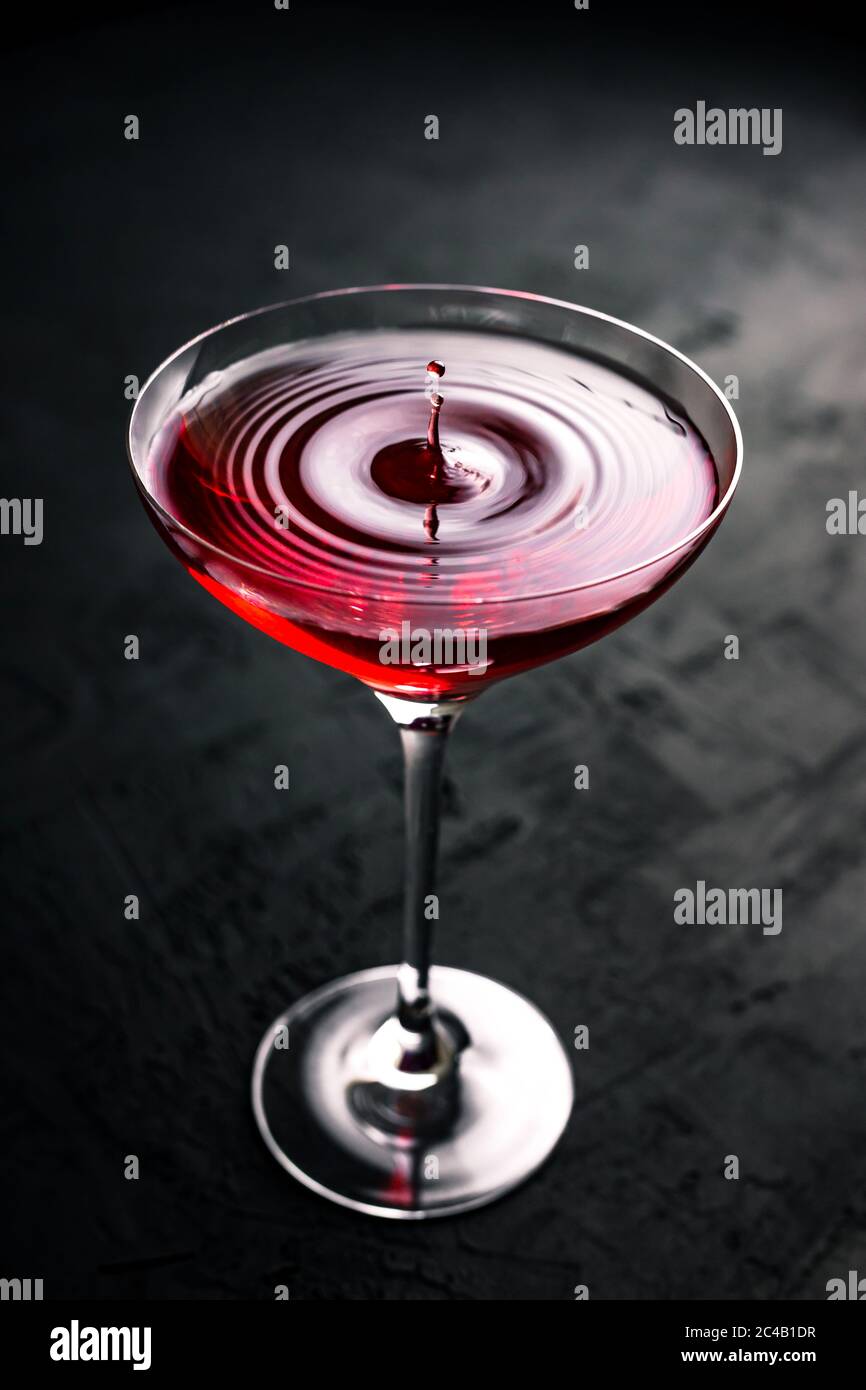A drop falling into a beautiful cocktail glass with cosmopolitan Stock ...