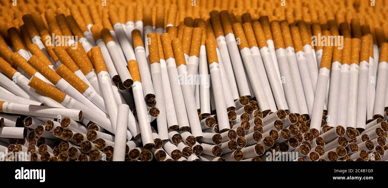 Many loose cigarettes background Stock Photo - Alamy