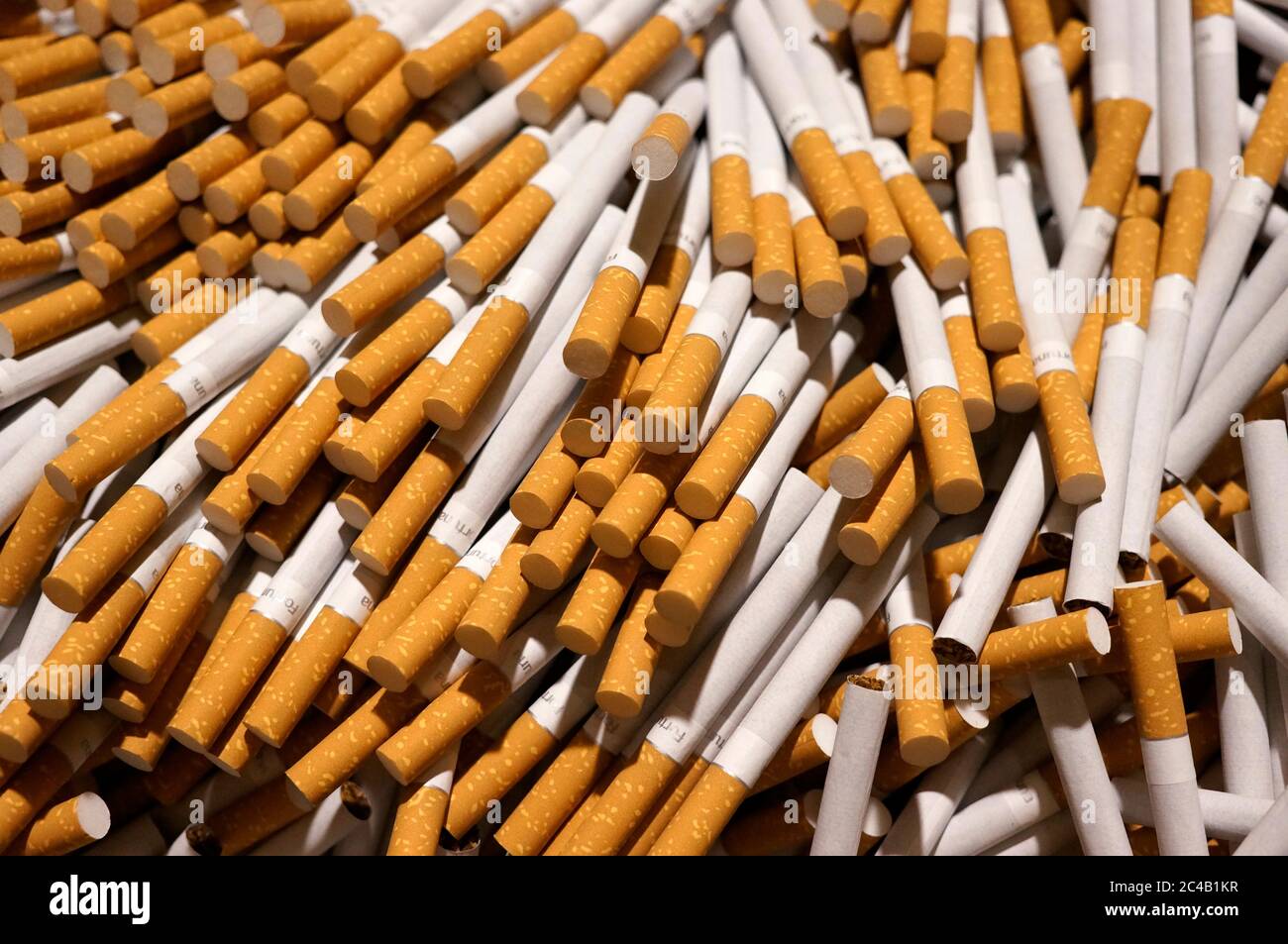 Many loose cigarettes background Stock Photo - Alamy
