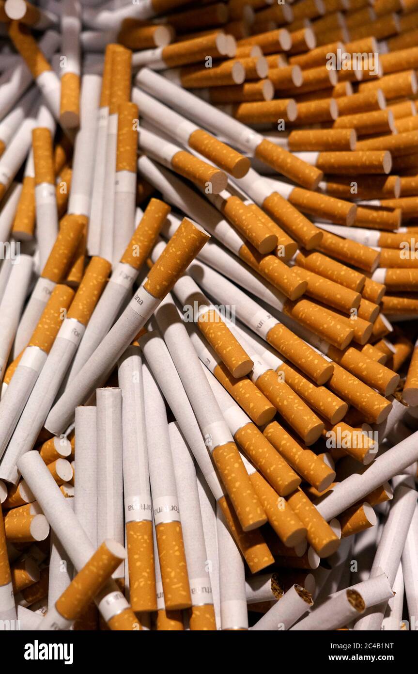 Many loose cigarettes background Stock Photo - Alamy