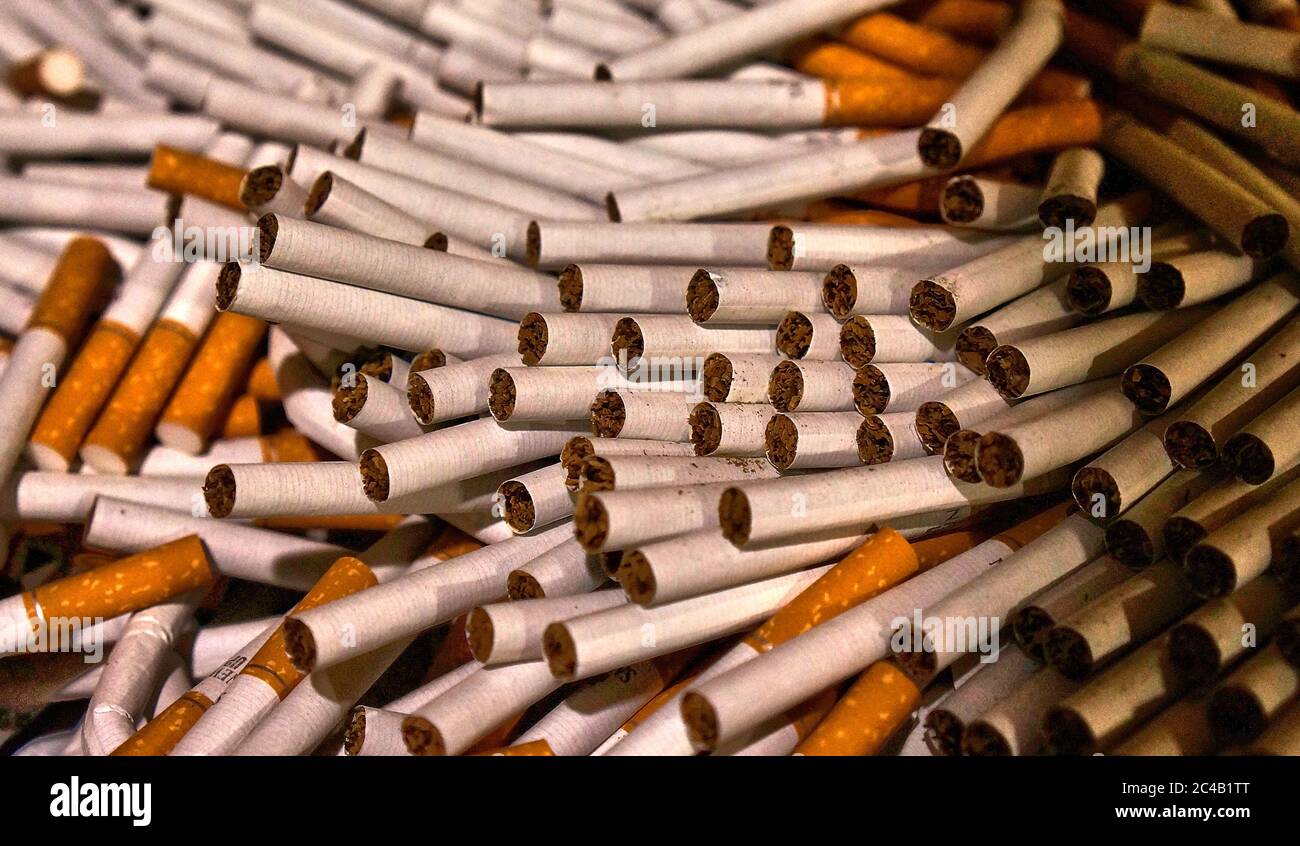 Many loose cigarettes background Stock Photo - Alamy