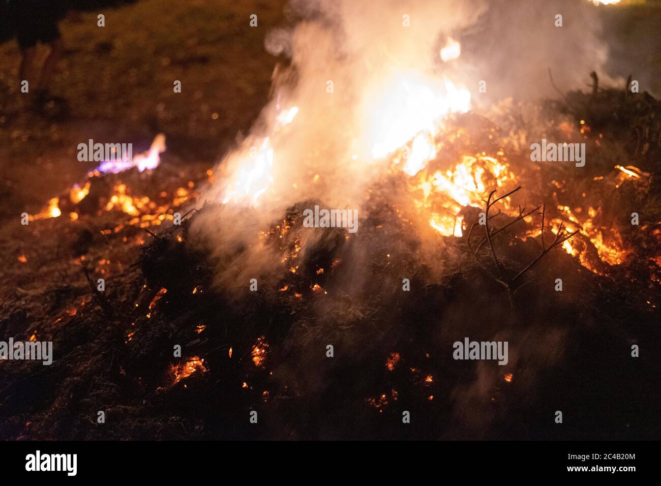Big pile of ashes burning in the night Stock Photo - Alamy