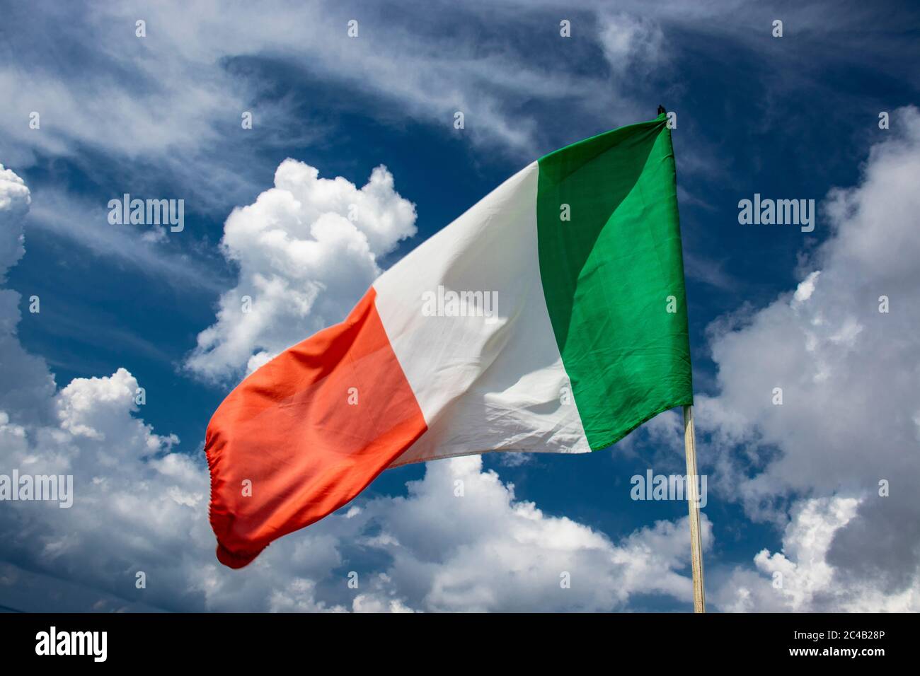 Italian flag waving in the blue sky Stock Photo - Alamy