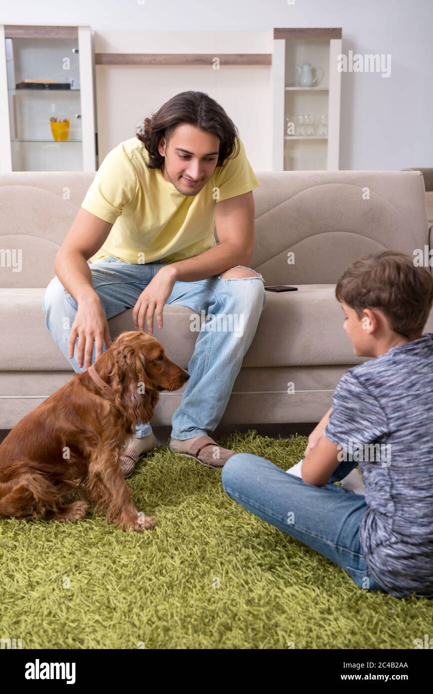 Young father and son with cocker spaniel dog Stock Photo - Alamy