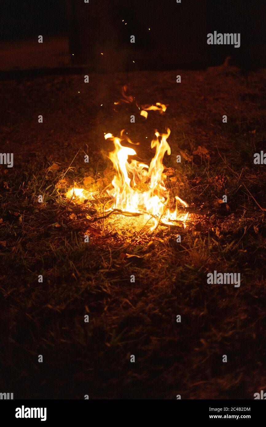 Small campfire in the middle of the field Stock Photo - Alamy