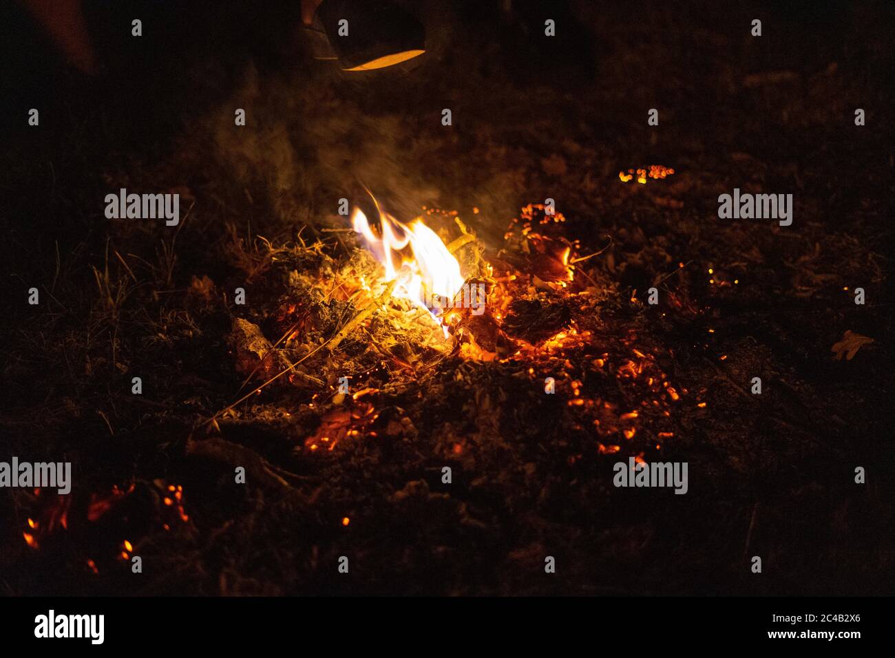 Small campfire in the middle of the field Stock Photo - Alamy