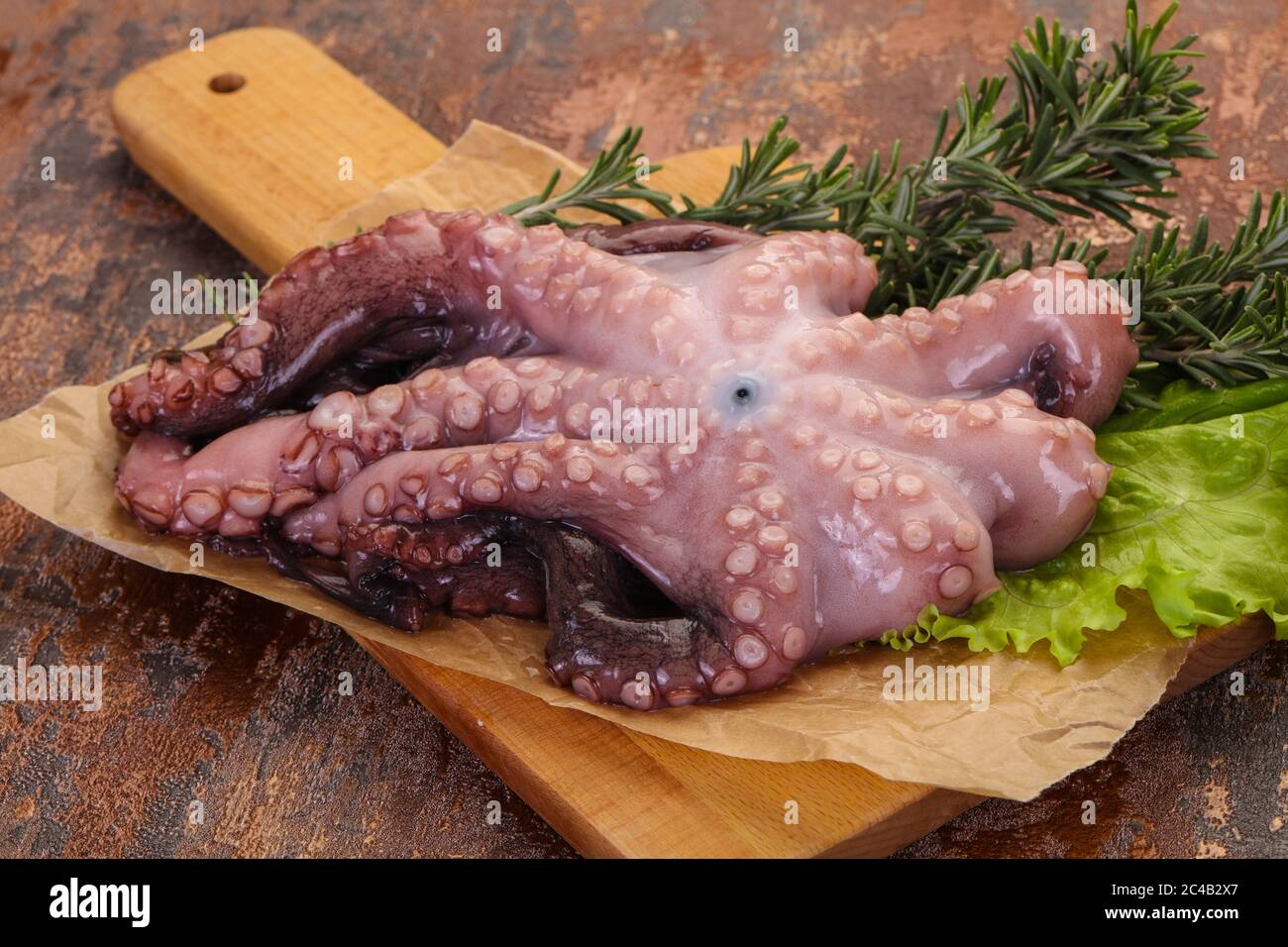 Raw octopus ready for cooking with rosemary Stock Photo - Alamy