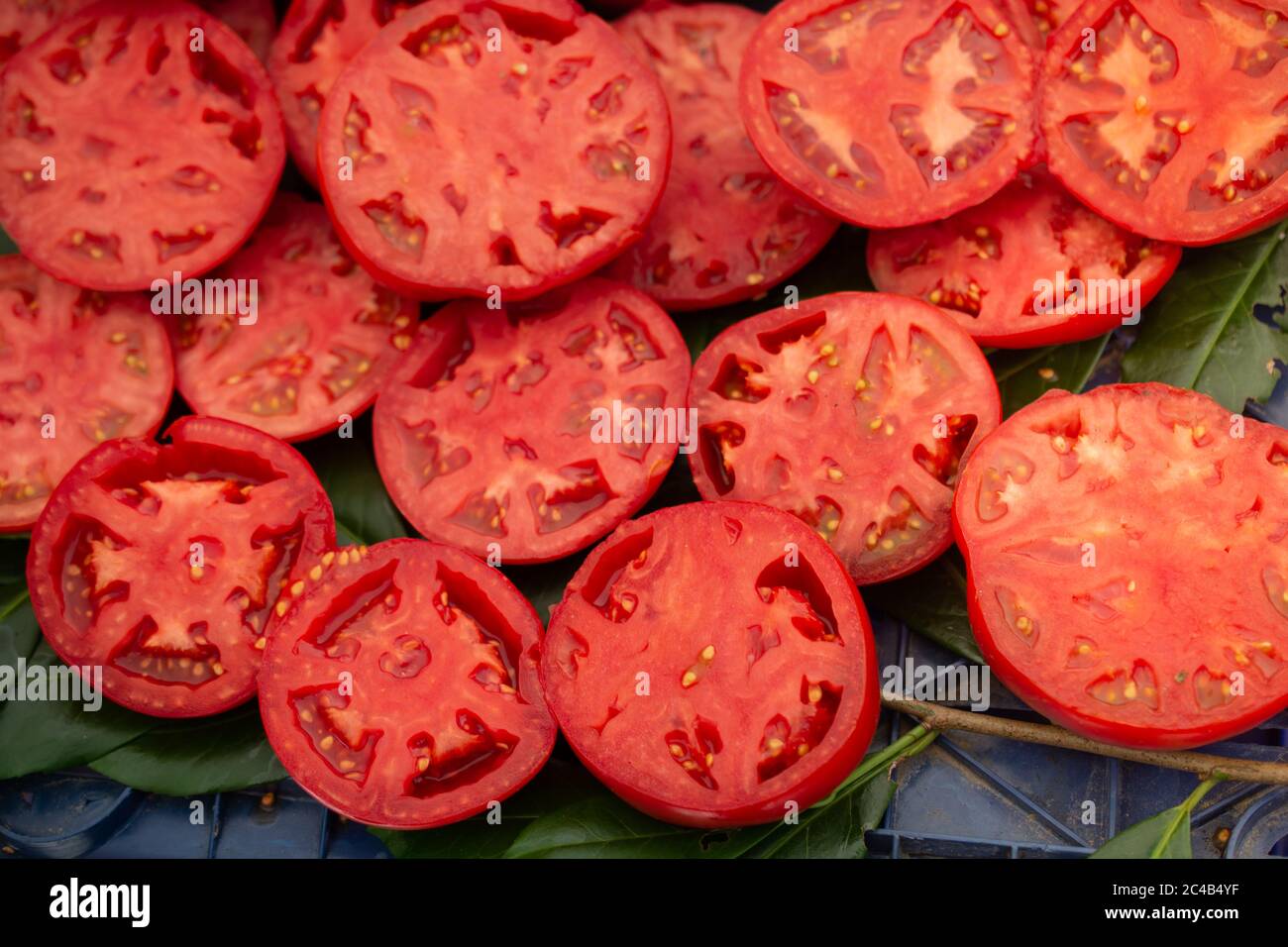Fresh cut tomato at grocery store for food backgrounds concept Stock ...