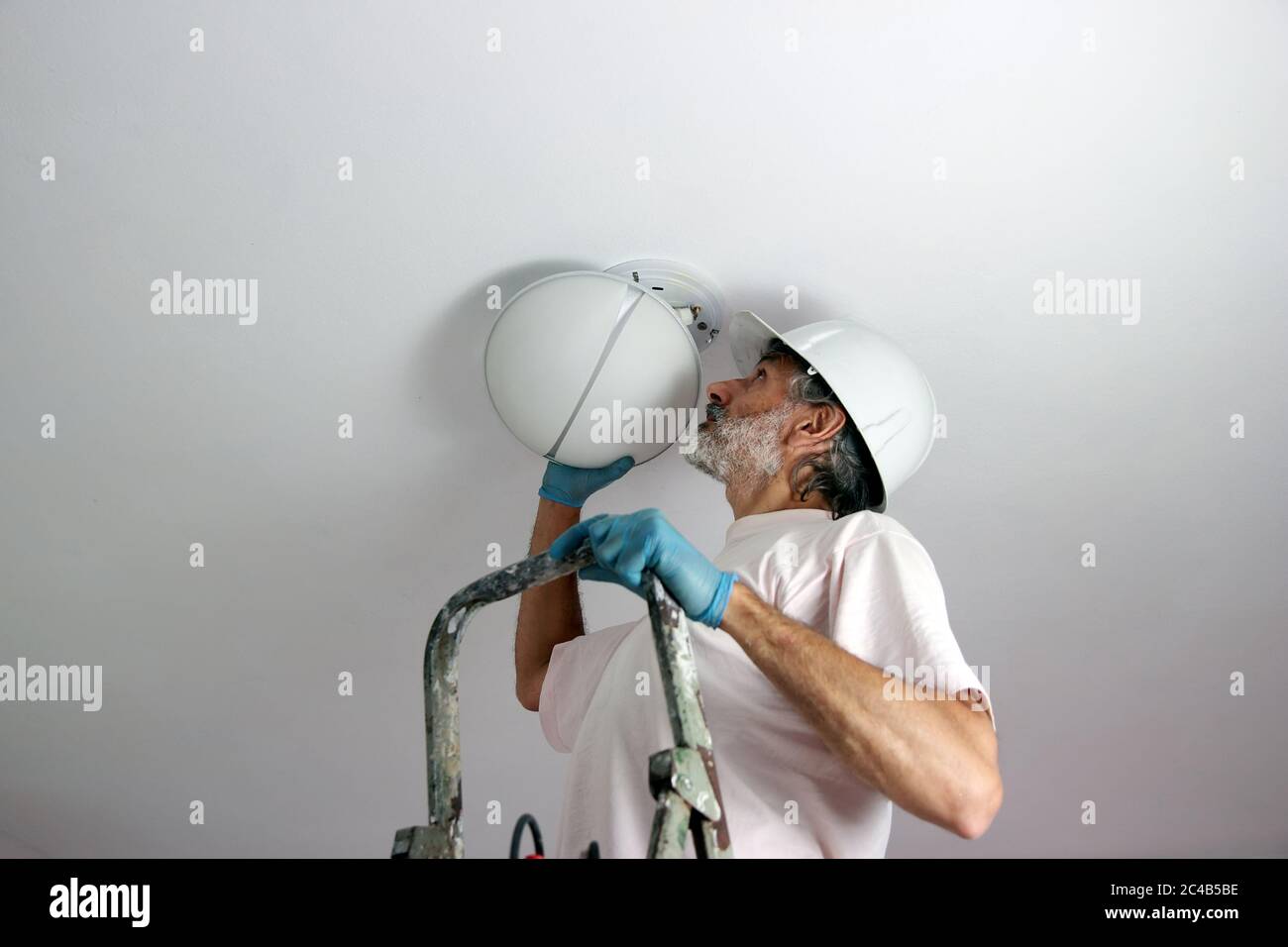 Installing lamp on ceiling hi-res stock photography and images - Alamy