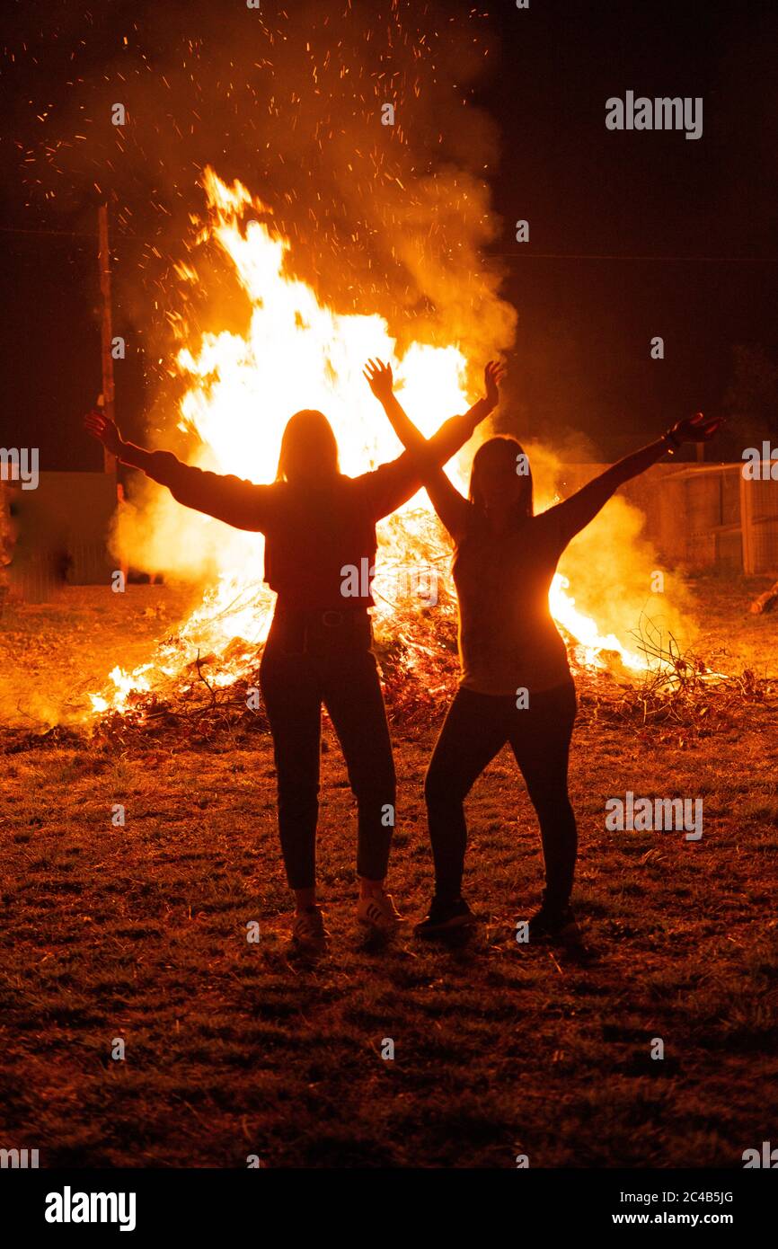 two friends in front of a giant fire Stock Photo - Alamy