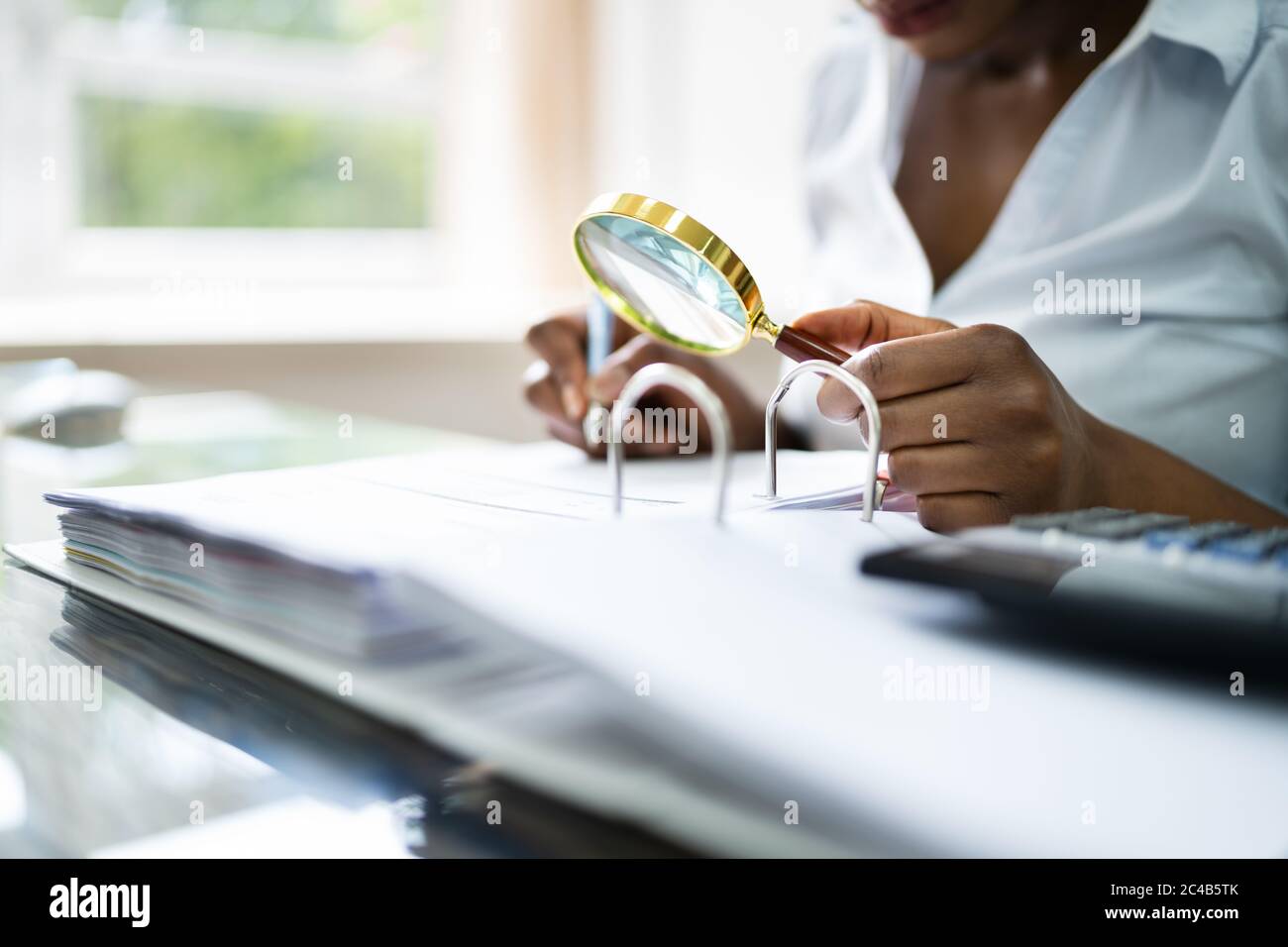 Auditor Investigating Business Fraud Using Magnifying Glass In Office ...