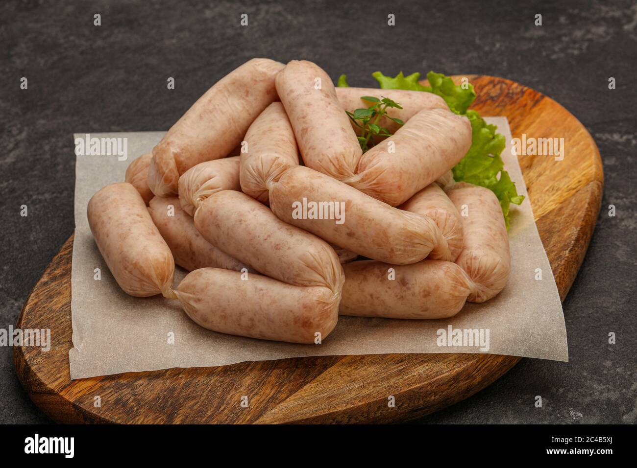 Raw natural chicken baby sausages for roast Stock Photo - Alamy