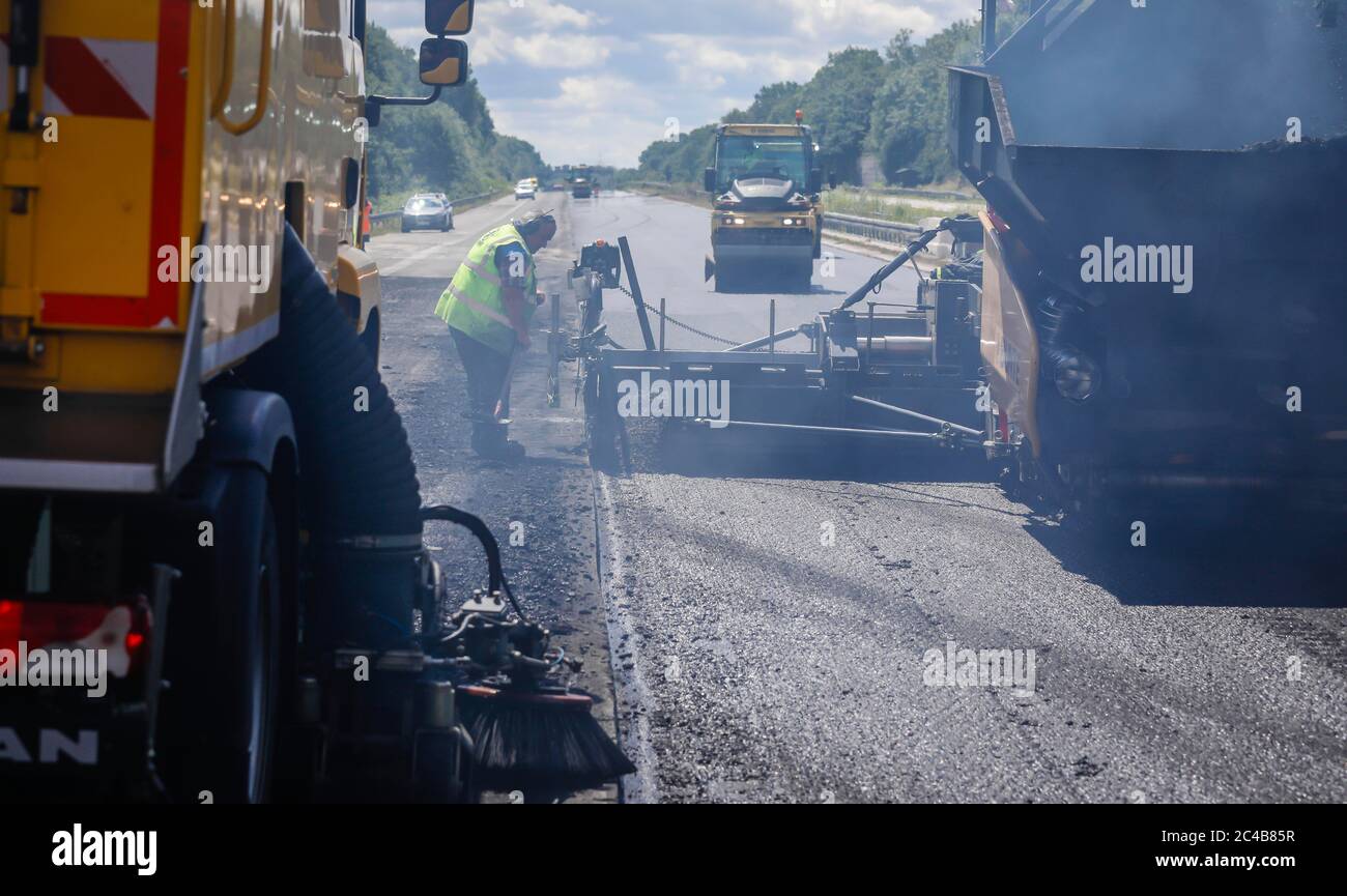 Road construction, asphalt pavers and road rollers use whisper asphalt ...
