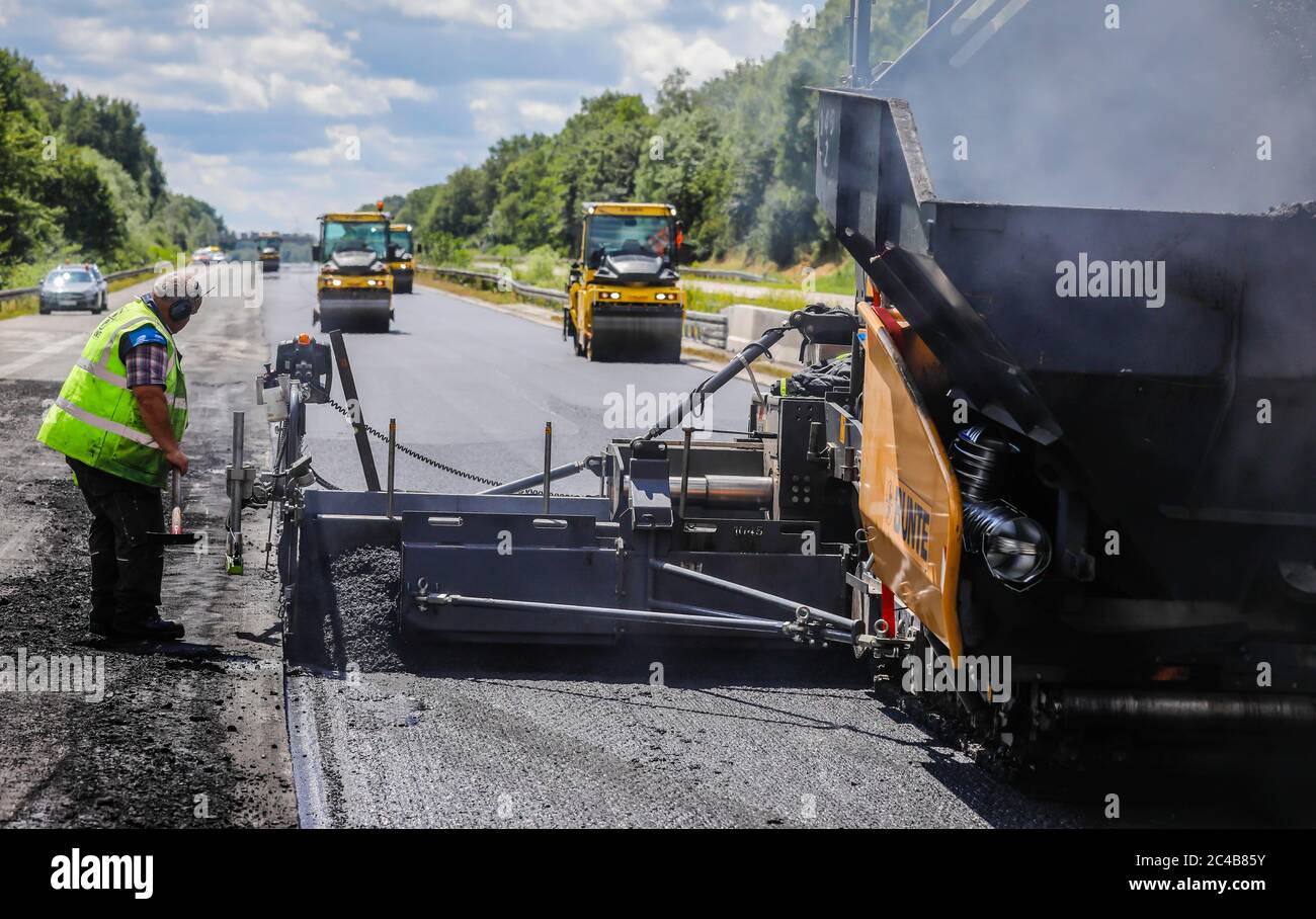 Road construction, asphalt pavers and road rollers use whisper asphalt ...