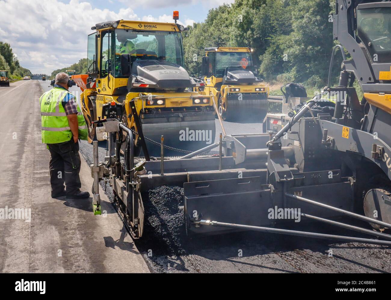 Road construction, asphalt pavers and road rollers use whisper asphalt ...
