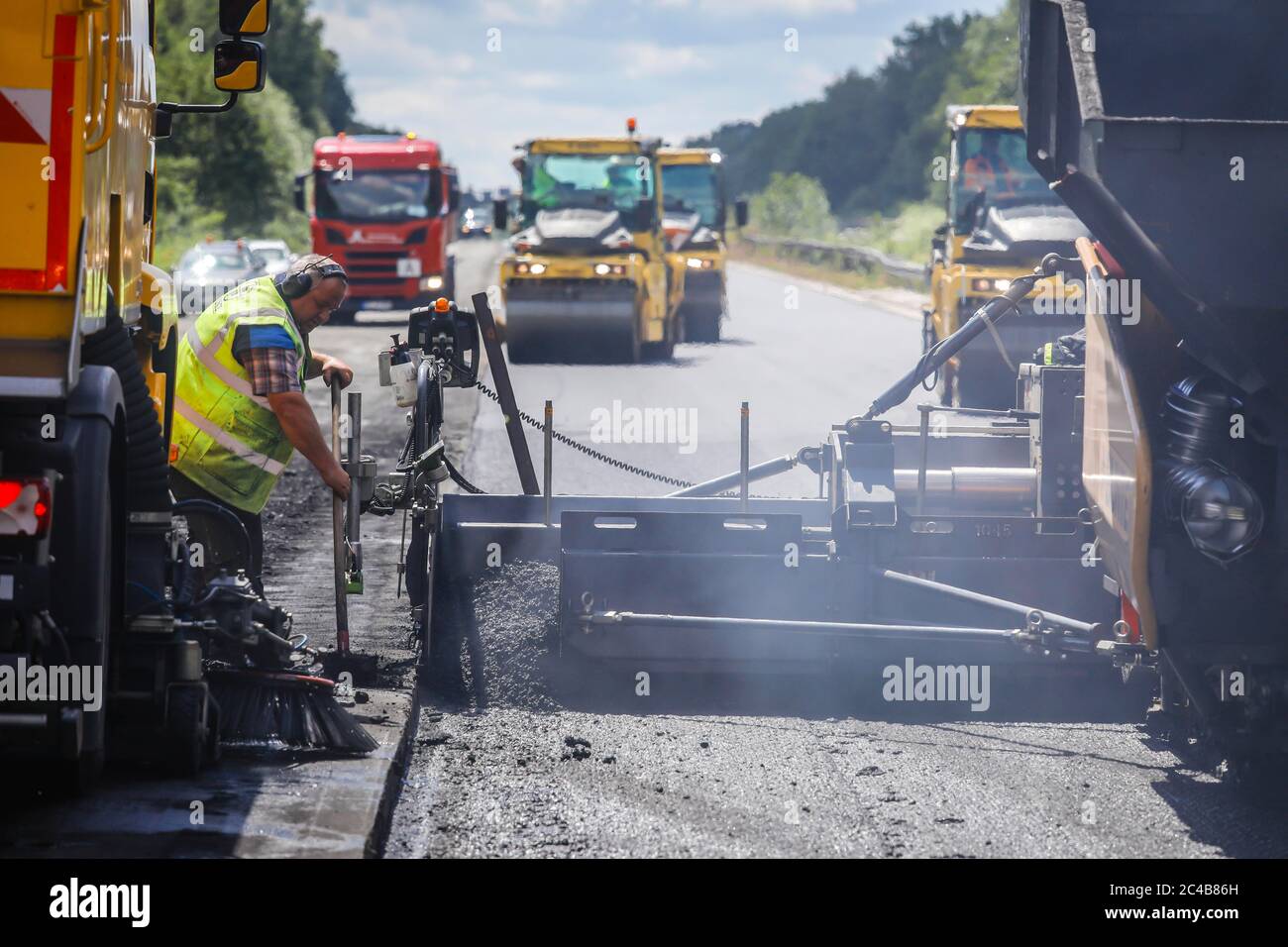 Road construction, asphalt pavers and road rollers use whisper asphalt ...