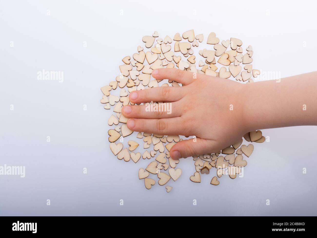 Retro style wooden hearts under hand as love concept Stock Photo - Alamy