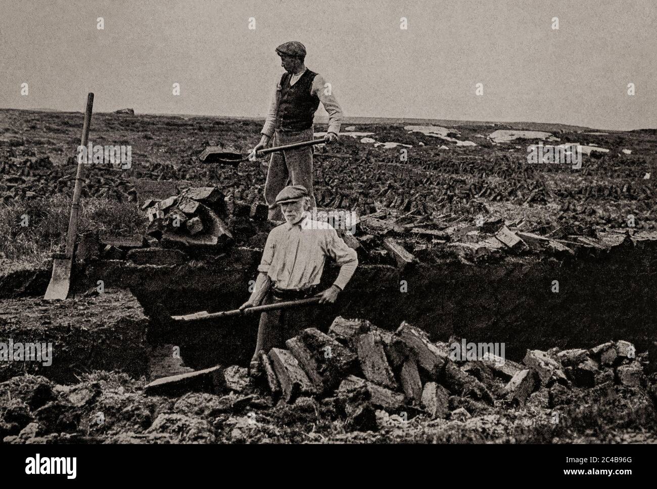 An early 1920's view of local people digging out turf (or peat) with a ...