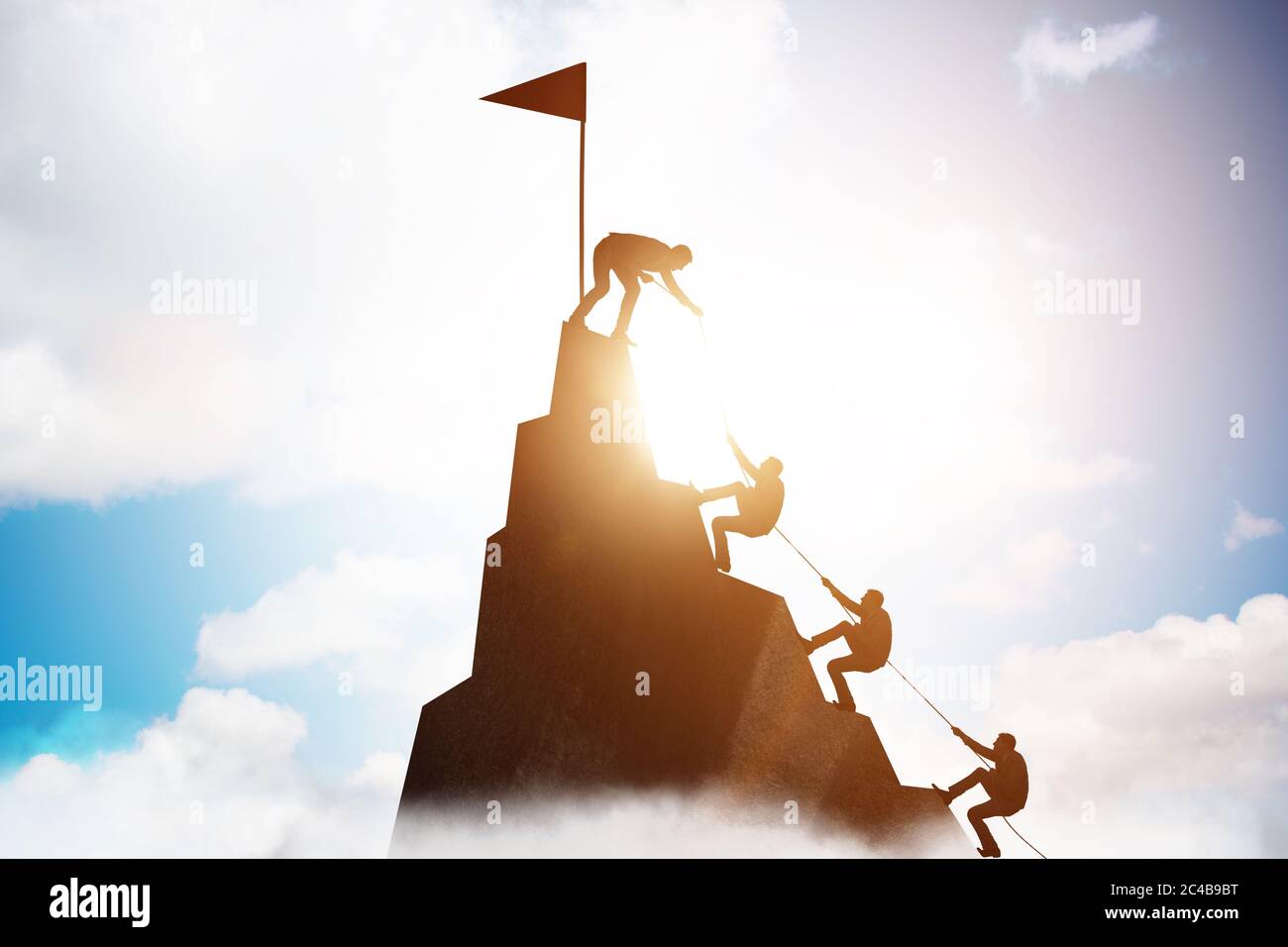 Concept of teamwork with team climbing mountain Stock Photo - Alamy